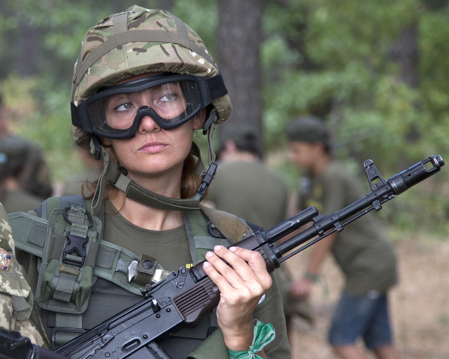 A schoolteacher in a military uniform watches as servicemen teach ...