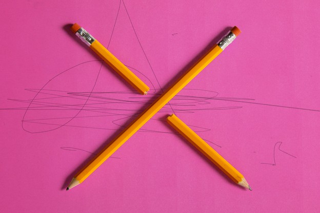 Two pencils, one broken, form an X