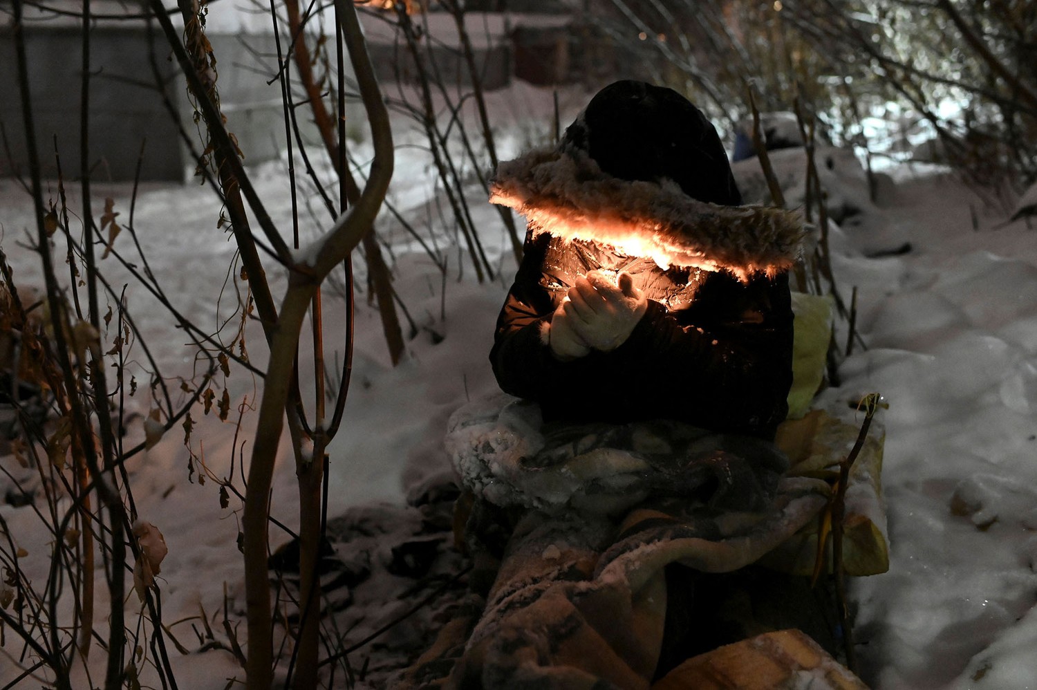 Lyusya Stepanova, 44, who is homeless, lights a cigarette after waking ...