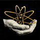 Illustration of a black-and-white human hand holding a giant golden atom