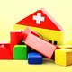 An illustration of building blocks with a Red Cross symbol on one.