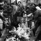 A black and white photo of Iranian protestors burning an image of the Shah