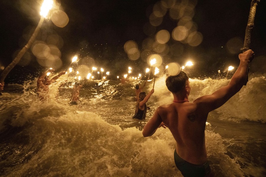 Photos of the Week: Surf Torch, Lion Dance, Pancake Race - The Atlantic