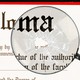 A broken magnifying glass being used to examine a diploma