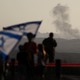 Smoke rises from Gaza as Israeli right-wing activists take part in a rally organized by settlers groups to promote Israel's resettling in Gaza, as seen from the Israeli side of the Israel-Gaza border.